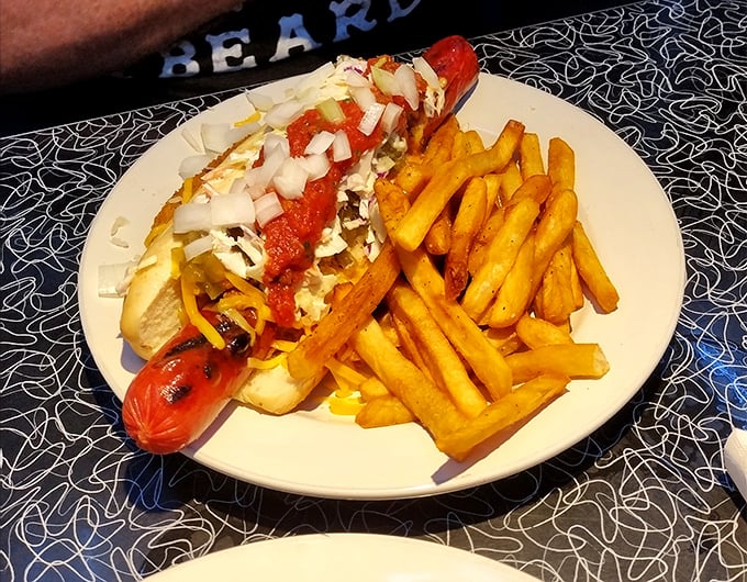 This isn't just any hot dog—it's a foot-long flavor rocket topped with enough fixings to require NASA-level engineering just to take the first bite.