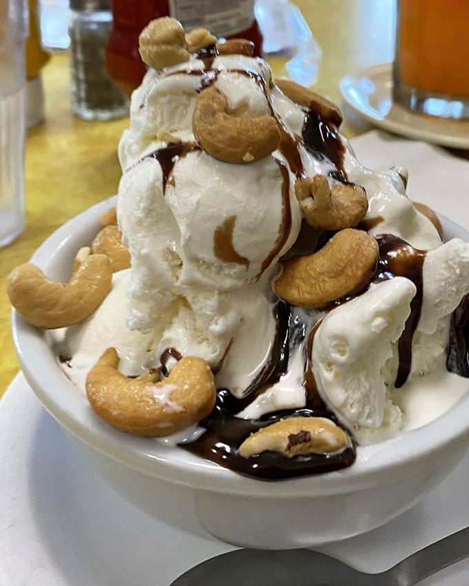 Ice cream architecture at its finest. Those cashews aren't just toppings—they're the crown jewels in a kingdom of vanilla and hot fudge. 