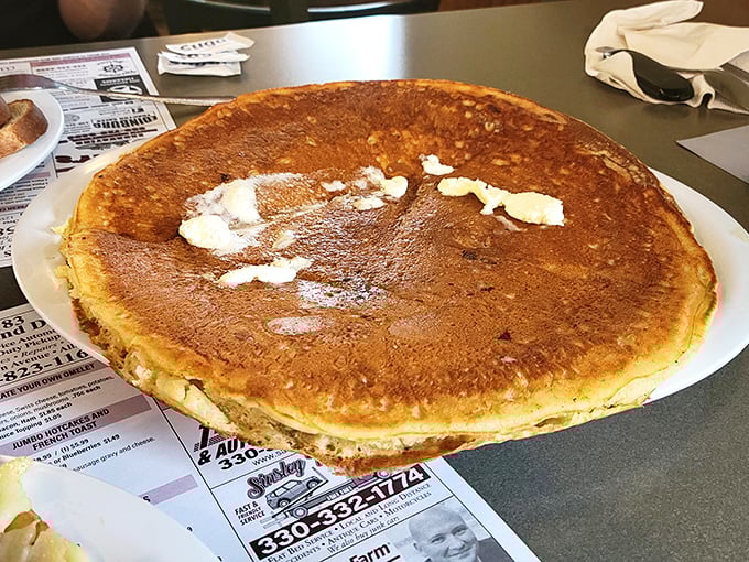 This pancake doesn't just hang over the edge of the plate—it's practically filing for its own zip code.