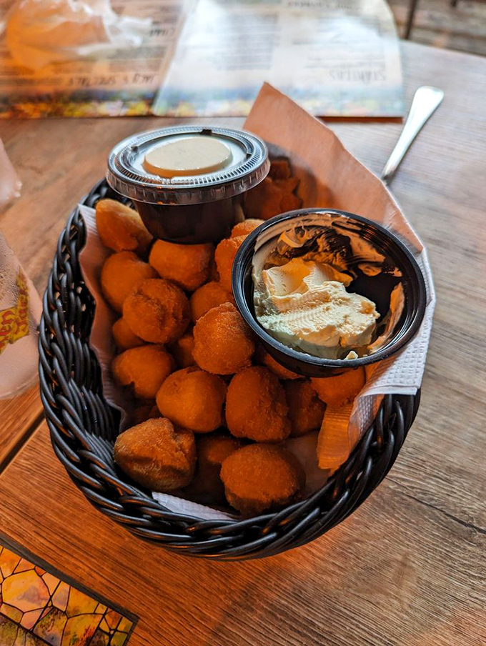 Golden hushpuppies that crunch then melt, served with honey butter that'll make you question why you've wasted time on lesser bread baskets.