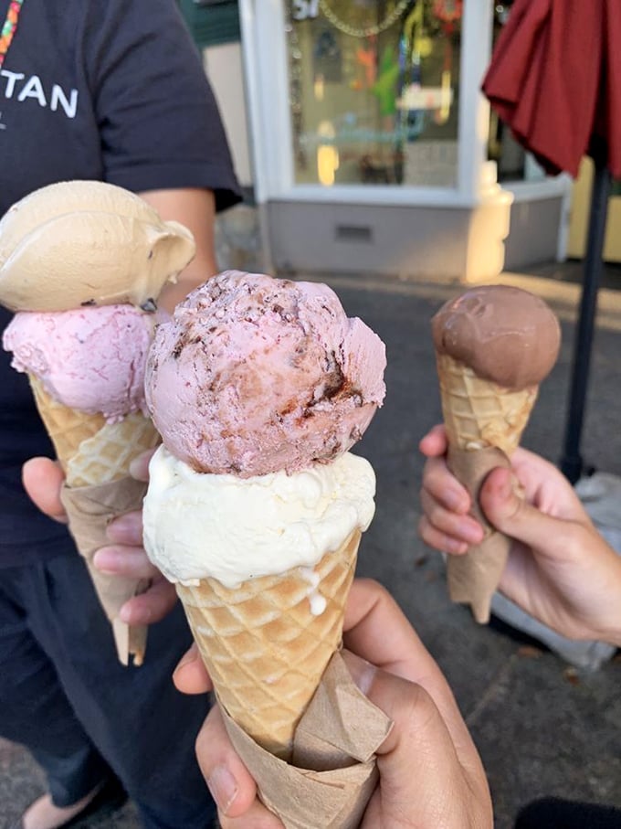 Ice cream architecture at its finest—towers of pink, white, and chocolate perfection balanced on handmade waffle cones.