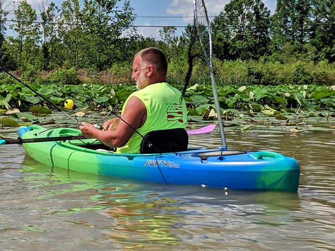 Paddling through lily pads – this kayaker has found the sweet spot between adventure and serenity in Rocky Fork's aquatic wilderness.