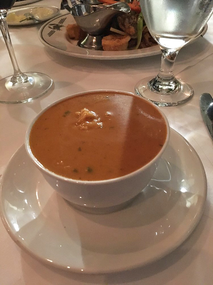 The Lobster Bisque arrives like a liquid sonnet—velvety, rich, and telling tales of crustacean adventures with each spoonful.