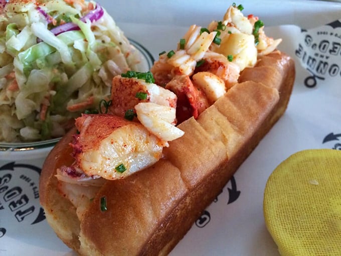 Behold the lobster roll in its natural habitat—buttery, toasted perfection cradling sweet chunks of lobster. The coleslaw isn't jealous; it knows its supporting role.