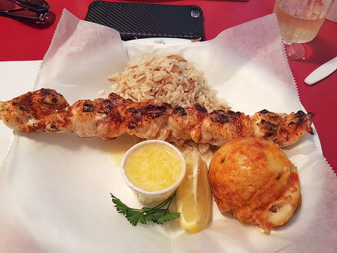 Lobster on a skewer: where simplicity meets luxury. That drawn butter cup isn't optional—it's essential equipment for this maritime adventure.