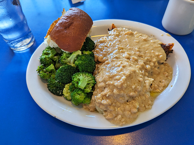 Behold the star attraction: meatloaf swimming in savory gravy alongside fresh broccoli. This isn't your mother's meatloaf—unless your mother was secretly a culinary genius.