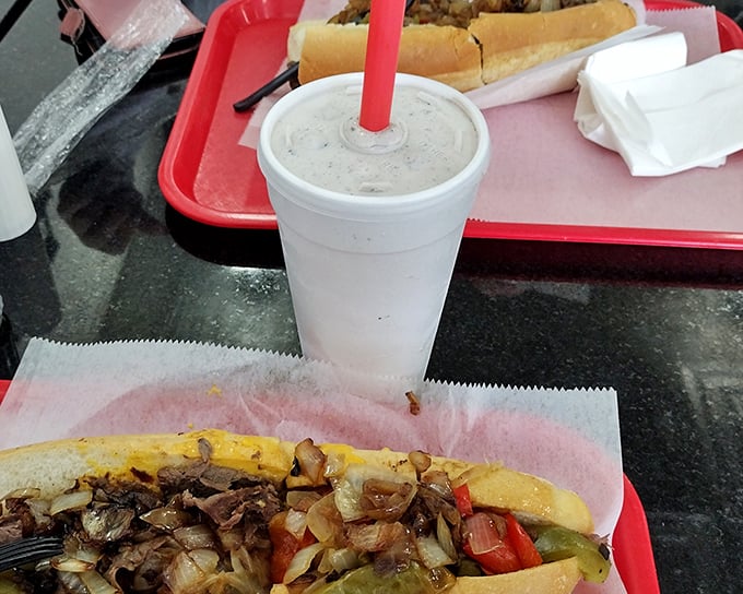 That milkshake moment – when your straw meets creamy perfection alongside a proper cheesesteak. Life's simple pleasures in perfect harmony.