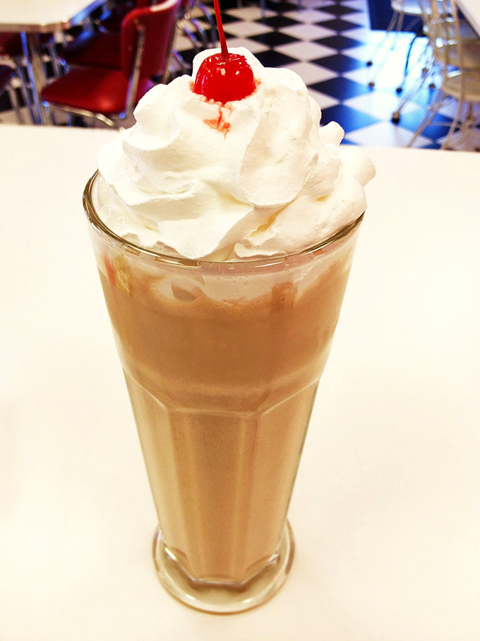 Not all heroes wear capes—some come in tall glasses with whipped cream mountains and a cherry sentinel standing guard over creamy perfection.