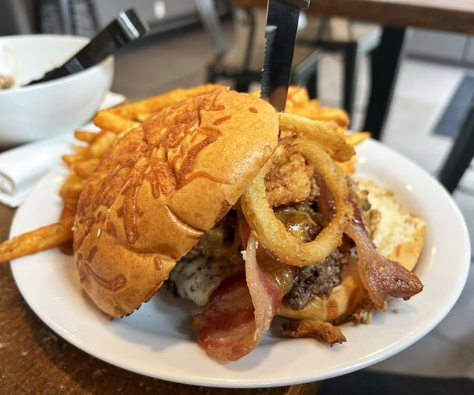 Not all heroes wear capes, but this burger wears crispy onion rings and bacon like medals of honor. Your diet plan's worthy nemesis.