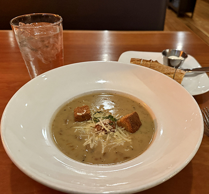 Behold the infamous mushroom soup! Those croutons aren't floating – they're doing the backstroke in a pool of earthy perfection.
