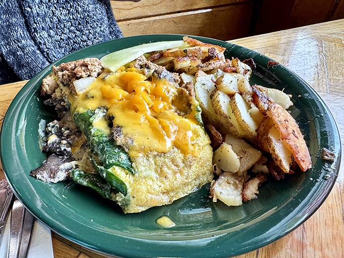 This isn't just an omelet—it's a masterpiece of morning artistry, where cheese cascades over vegetables like a sunrise over Tahoe.