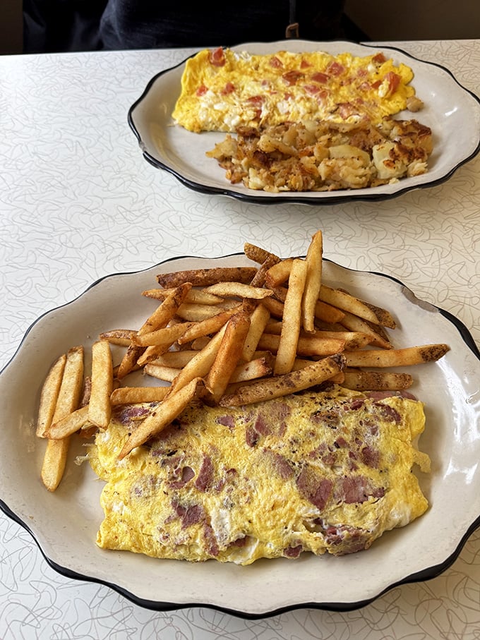 Golden perfection on a plate—this omelet doesn't need fancy culinary school techniques, just decades of diner know-how and generous fillings.