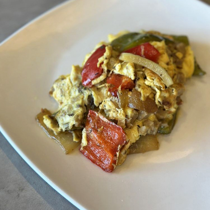 Not all heroes wear capes—some come on white plates, loaded with peppers and tomatoes in a perfectly executed veggie omelette.