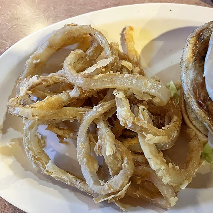 These aren't just onion rings—they're golden halos of happiness. Crispy, substantial, and perfectly seasoned, they're worth the drive to Carthage alone.