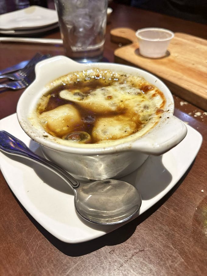 Behold the star attraction: French onion soup that makes you understand why people write songs about food. That cheese pull deserves its own Instagram account.