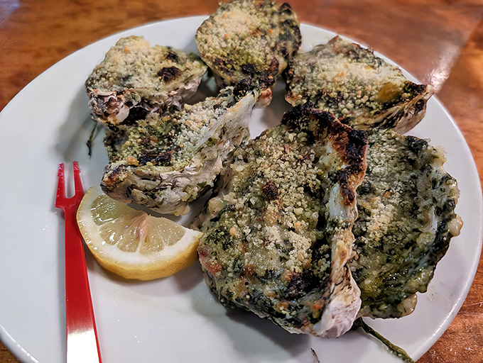 These herb-crusted oysters aren't just cooked, they're transformed – each shell a little vessel of buttery, garlicky bliss from the Virginia waters.