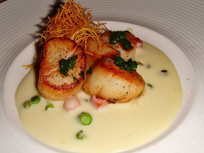 These scallops aren't just seared—they're transformed into buttery islands of perfection in a sea of velvety sauce. Ocean poetry on a plate.
