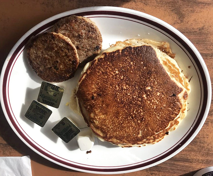 Golden-brown pancakes with a perfect crisp edge paired with sausage patties—proof that breakfast perfection doesn't require complicated techniques, just respect for tradition.