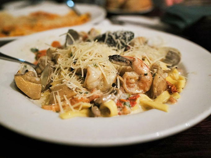 Seafood pasta perfection – plump shrimp and tender shellfish nestled among fresh pasta, all crowned with a snowfall of Parmesan.