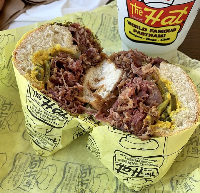 Not so much a sandwich as a pastrami skyscraper – this architectural marvel requires both hands, multiple napkins, and zero shame.