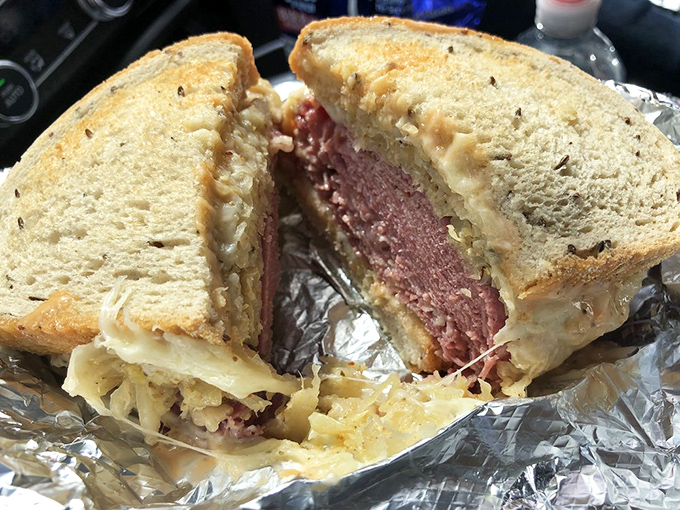 Behold the pastrami sandwich in its natural habitat—perfectly grilled rye creating that crucial textural contrast with the tender meat within. Poetry between bread.