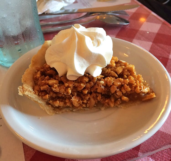 The legendary peanut pie in all its glory. That dollop of whipped cream isn't just garnish—it's the perfect dance partner.