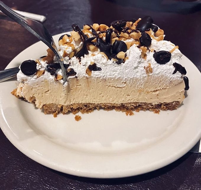 Behold the legendary peanut butter pie! That perfect balance of creamy filling, chocolate drizzle, and whipped cream could make a grown adult weep with joy.