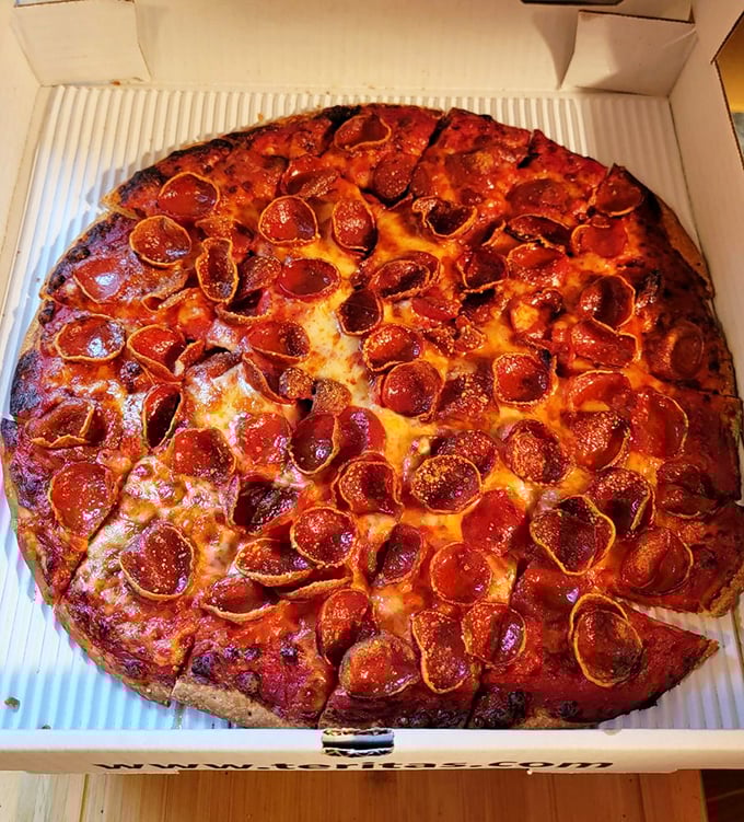 Behold the star attraction: pepperoni that curls into perfect little cups of spicy, crispy-edged glory. This isn't just pizza—it's edible art.