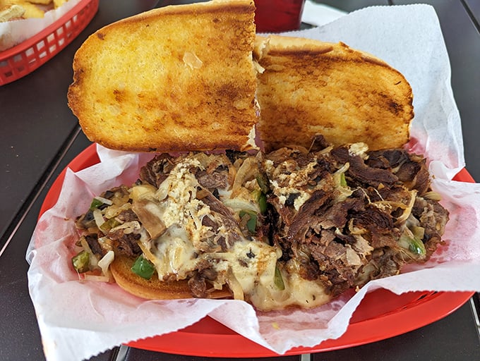 This isn't just a Philly cheesesteak, it's edible architecture – a perfect marriage of toasted bread, melted cheese, and savory meat that demands a two-handed commitment.