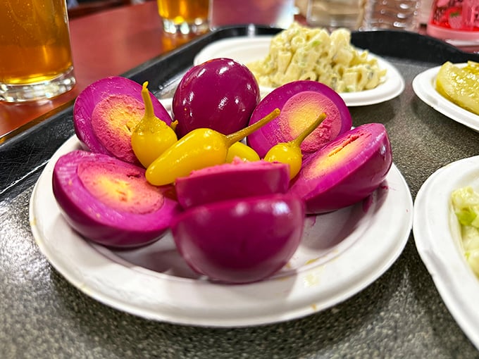 Those vibrant purple pickled eggs aren't just Instagram bait—they're a tangy time machine to when bar snacks were an art form.