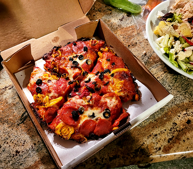 Pizza that makes you question every life decision that didn't involve eating this sooner. Those pepperoni cups are tiny pools of flavor heaven.
