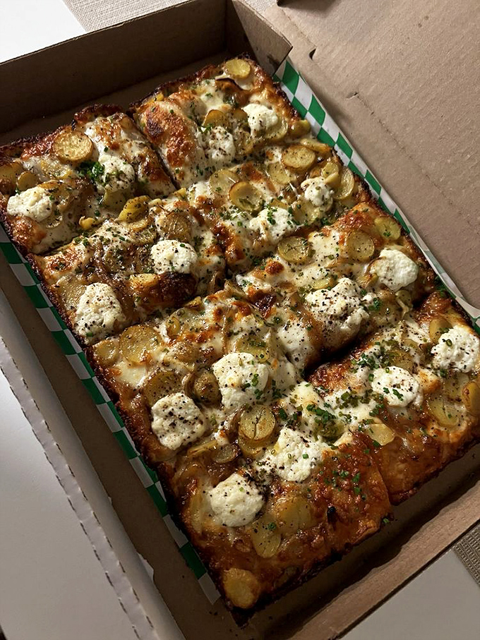 This isn't just pizza—it's architecture. Crispy-edged Detroit-style with potato slices and dollops of ricotta that make geometry delicious.