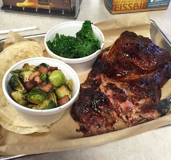 Behold the pork steak in all its glory—a glistening monument to smoke and patience. Those Brussels sprouts aren't just sidekicks.