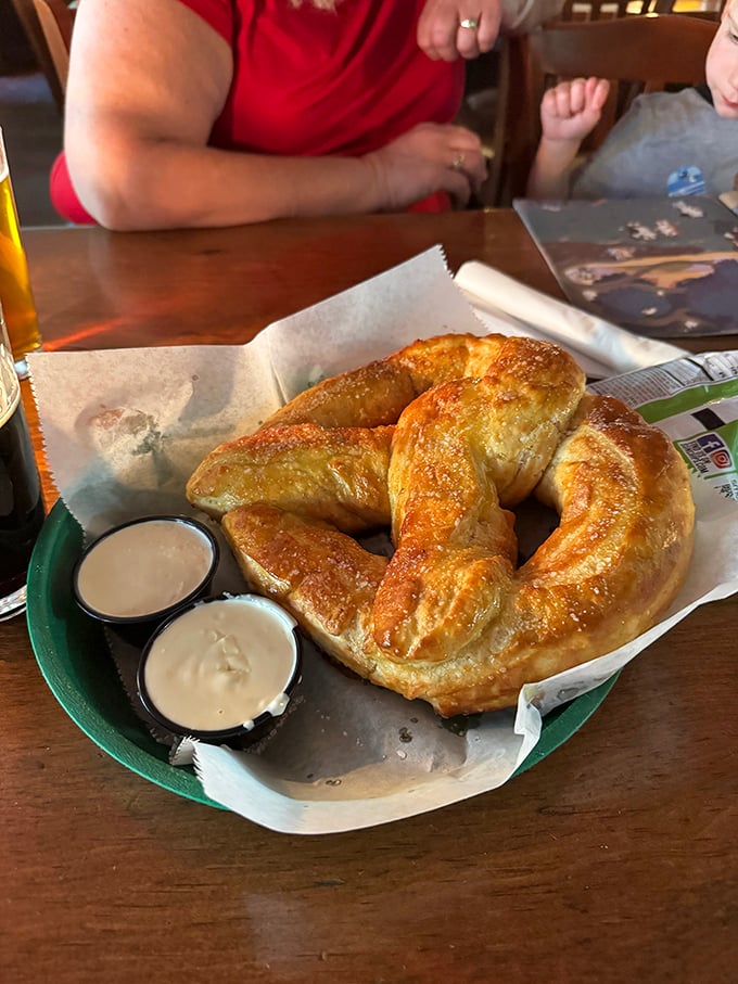 Behold the pretzel that launched a thousand road trips – golden, twisted perfection served with dipping sauces that make you question all other bread products.