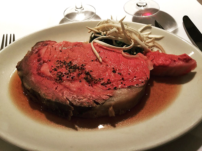 Behold the star of the show—rosy, succulent prime rib resting in its natural jus. This isn't just dinner; it's a carnivore's dream realized.