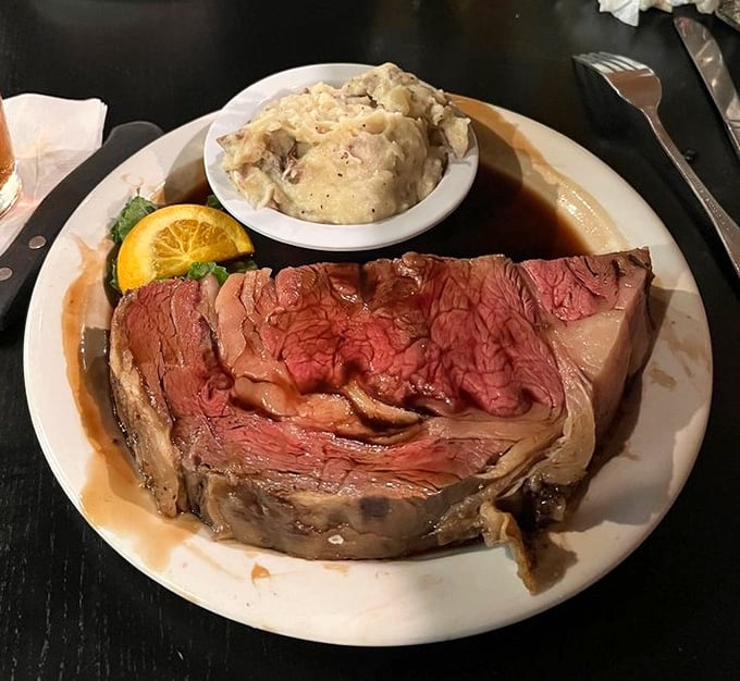 Behold the prime rib in all its glory—perfectly pink, impossibly tender, and served with a side of mashed potatoes that could make a grown adult weep with joy.
