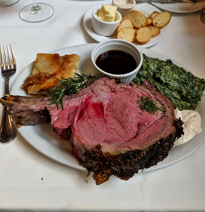 This prime rib isn't just dinner; it's a carnivorous masterpiece with a supporting cast of creamed spinach and Yorkshire pudding.