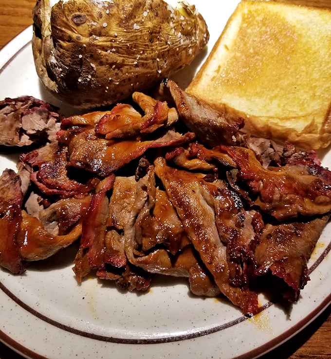 Tender, smoky pulled pork that practically dissolves on contact – this isn't just barbecue, it's edible poetry with a side of Texas toast.