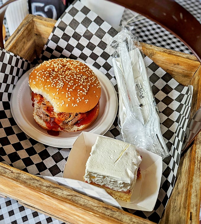 The star of the show arrives! This BBQ pulled pork sandwich on a sesame seed bun isn't just lunch—it's the reason people drive across counties.