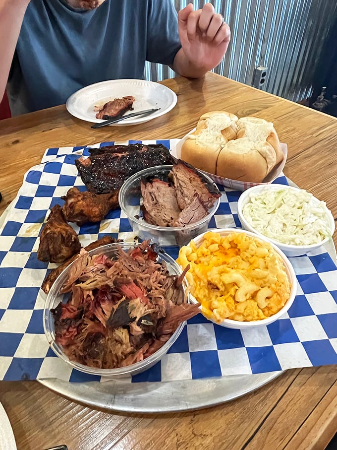 Barbecue heaven on a blue-checkered altar. This sampler platter doesn't just speak to you—it sings a full-throated carnivore's anthem.