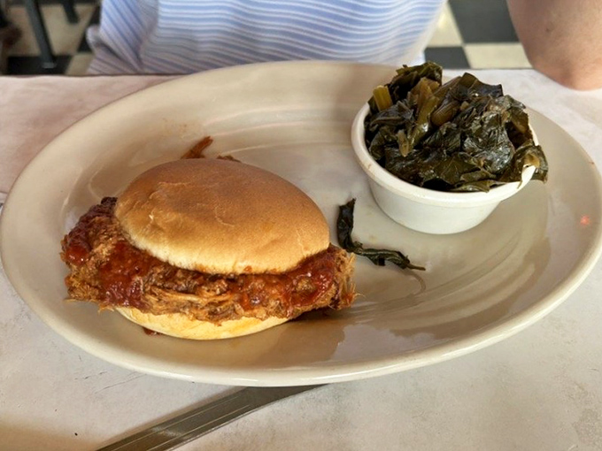 The star of the show: a pulled pork sandwich that doesn't need fancy plating to make your mouth water, paired with collards that mean business.