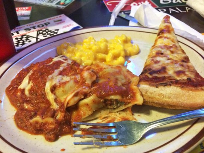 Behold the holy trinity: golden ravioli swimming in sauce, mac and cheese, and pizza – carb heaven achieved.