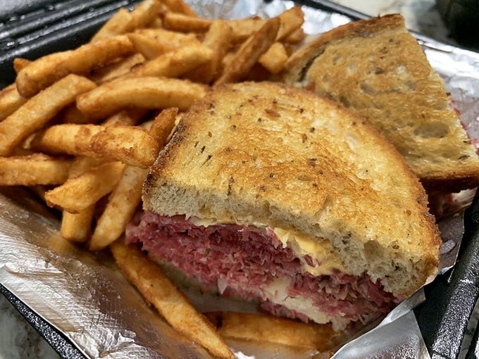 Behold the star of the show—a Reuben sandwich so perfectly constructed it deserves its own architectural award.