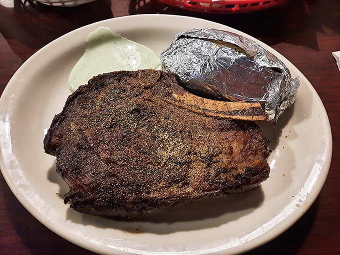 Behold the star attraction: a perfectly seasoned ribeye with a baked potato sidekick. This isn't just dinner; it's a religious experience.