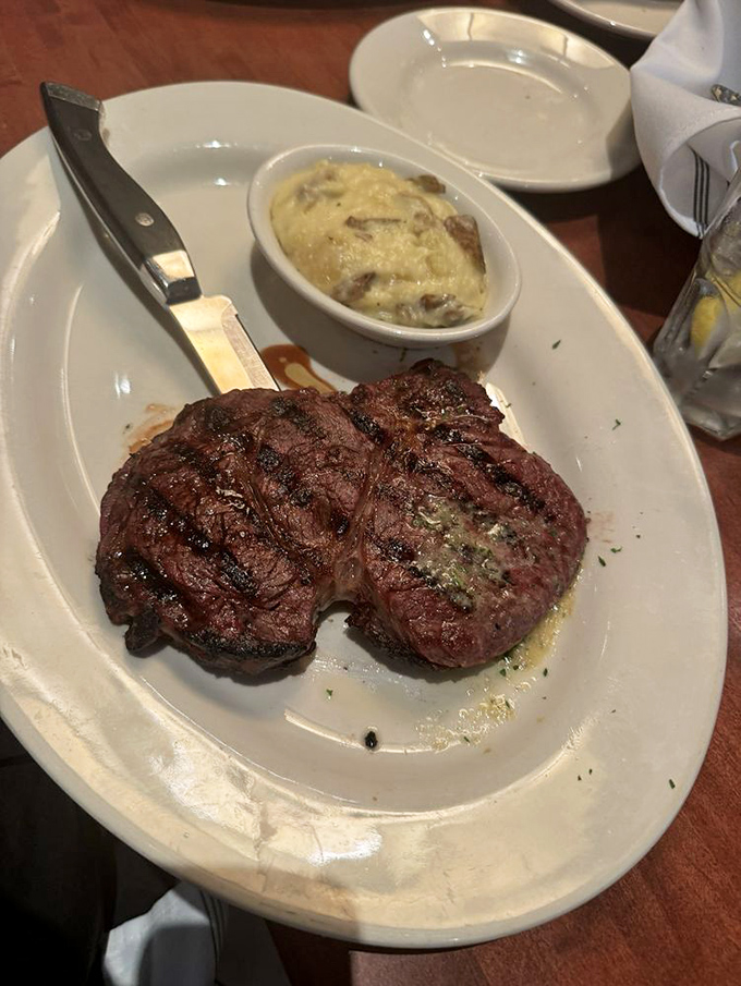 This isn't just a steak; it's a masterpiece of meat chemistry—perfectly seared filet medallions with a side of decadence in creamy potato form.
