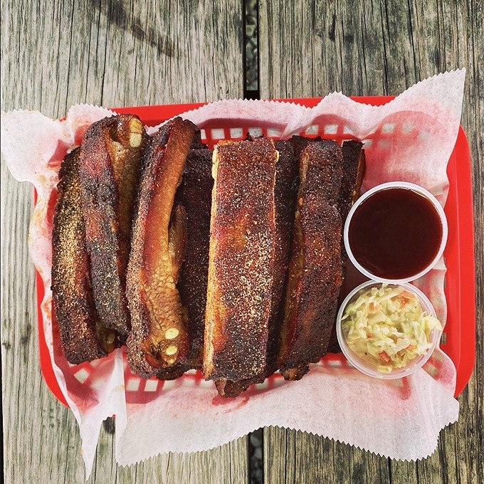 These ribs don't just fall off the bone—they make a compelling argument for why you should cancel your afternoon plans and order another rack.