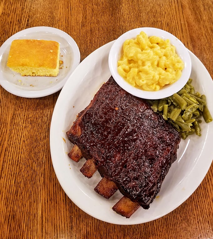 These ribs don't just fall off the bone—they practically leap into your mouth, bringing along mac and cheese that would make your childhood self weep with joy. 