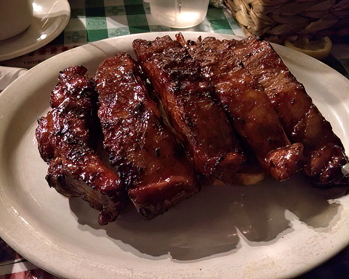 These ribs aren't falling off the bone—they're clinging to it with just enough integrity to remind you this is proper barbecue, not some overcooked pretender.
