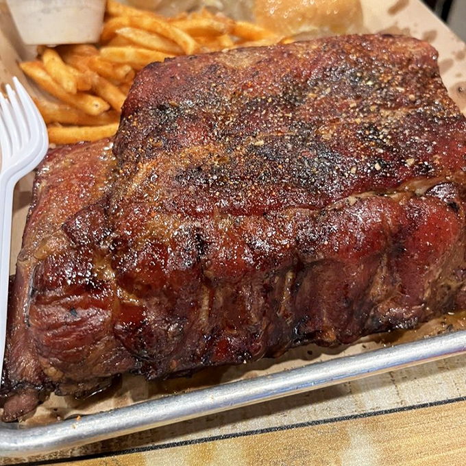 These ribs don't just fall off the bone—they practically leap into your mouth, sporting a bark so perfect it deserves its own exhibition.