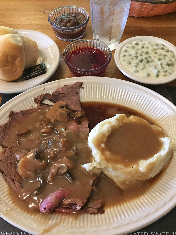 Behold the star attraction: roast beef so tender it practically surrenders to your fork, paired with mashed potatoes awaiting their gravy bath.